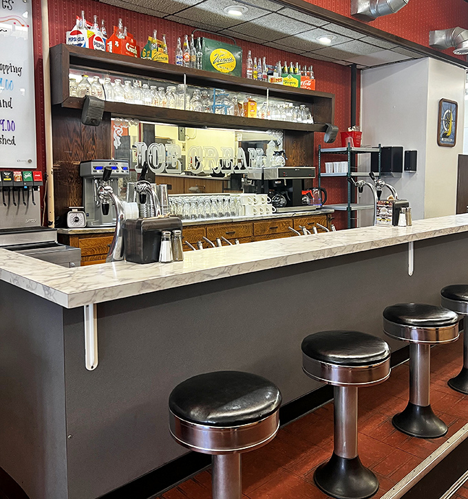 The soda fountain counter&mdash;where the real magic happens. Those gleaming dispensers aren't just equipment&mdash;they're time machines in stainless steel form.