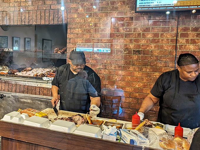 The magic happens behind the counter, where skilled hands transform humble cuts into barbecue masterpieces one order at a time.