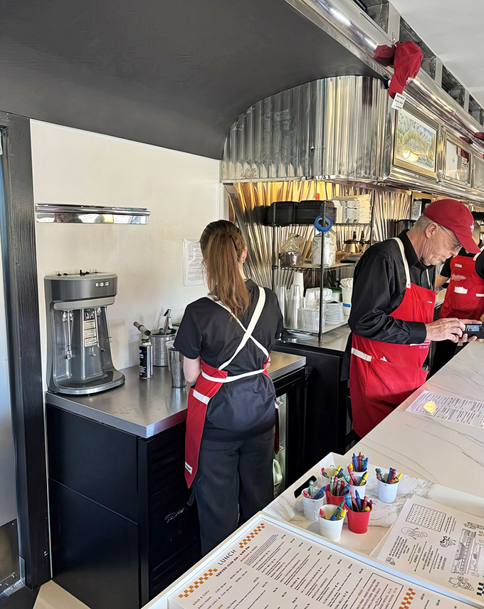 The kitchen dance&mdash;where efficiency meets passion. Those red aprons aren't just uniforms; they're superhero capes for the breakfast rush.