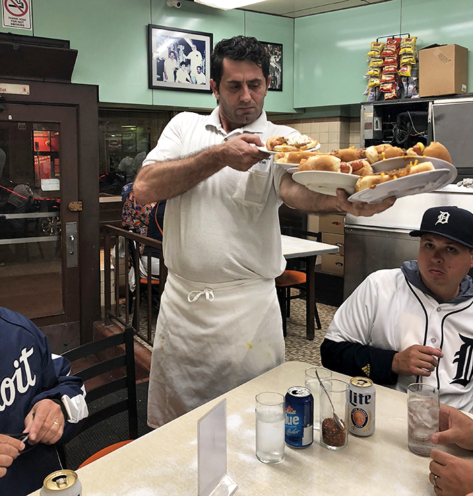 The culinary choreography of Lafayette &ndash; where servers transform simple ingredients into Detroit's most beloved street food.