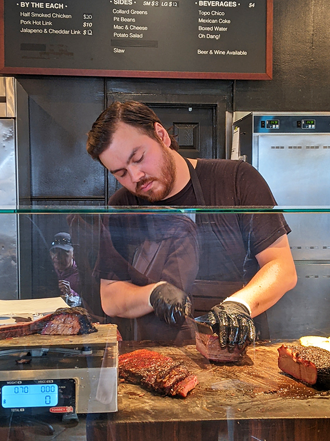 The maestro at work, turning raw meat into edible symphonies. Those gloves have touched more happiness than Santa Claus.