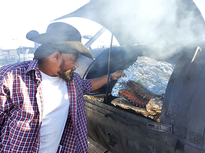 Checking on meat isn't just a job, it's a calling. That's not just smoke he's looking through&mdash;it's the veil between good and transcendent.