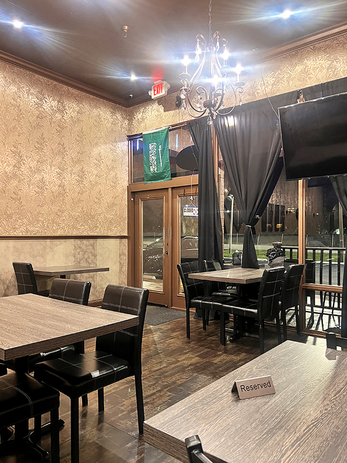 Golden wallpaper and elegant lighting create a dining room that feels worlds away from the Florida strip mall outside.