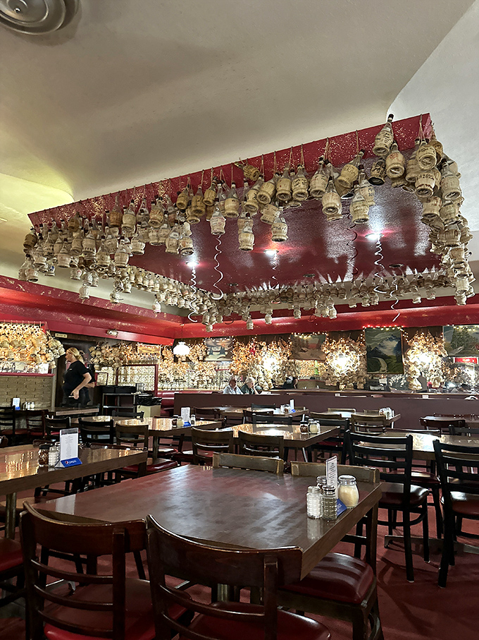 The dining room at Loui's feels like stepping into your Italian grandmother's basement—if she had excellent taste in wine bottles.