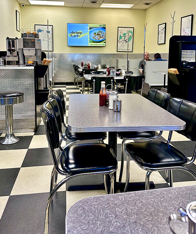 The quintessential diner tableau: gleaming tabletops, classic chairs, and condiments standing at attention, ready for the breakfast rush.