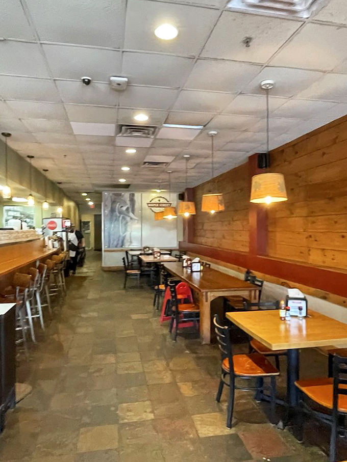 Rustic wooden tables await your elbows and food dreams. The warm tones and pendant lights create an atmosphere that says "stay awhile."