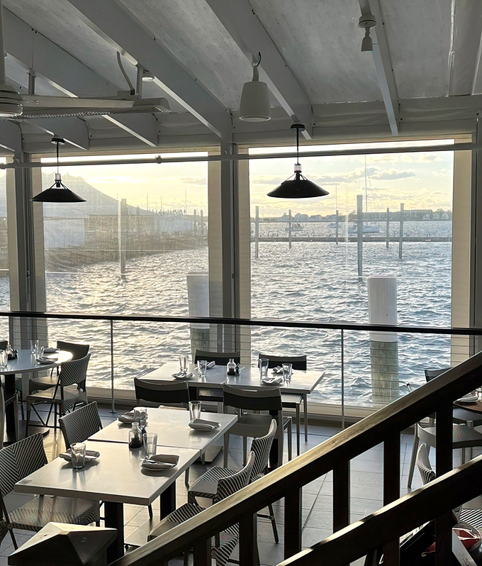 Floor-to-ceiling windows framing Newport Harbor like nature's most expensive flat-screen television, except the programming is always spectacular and free.