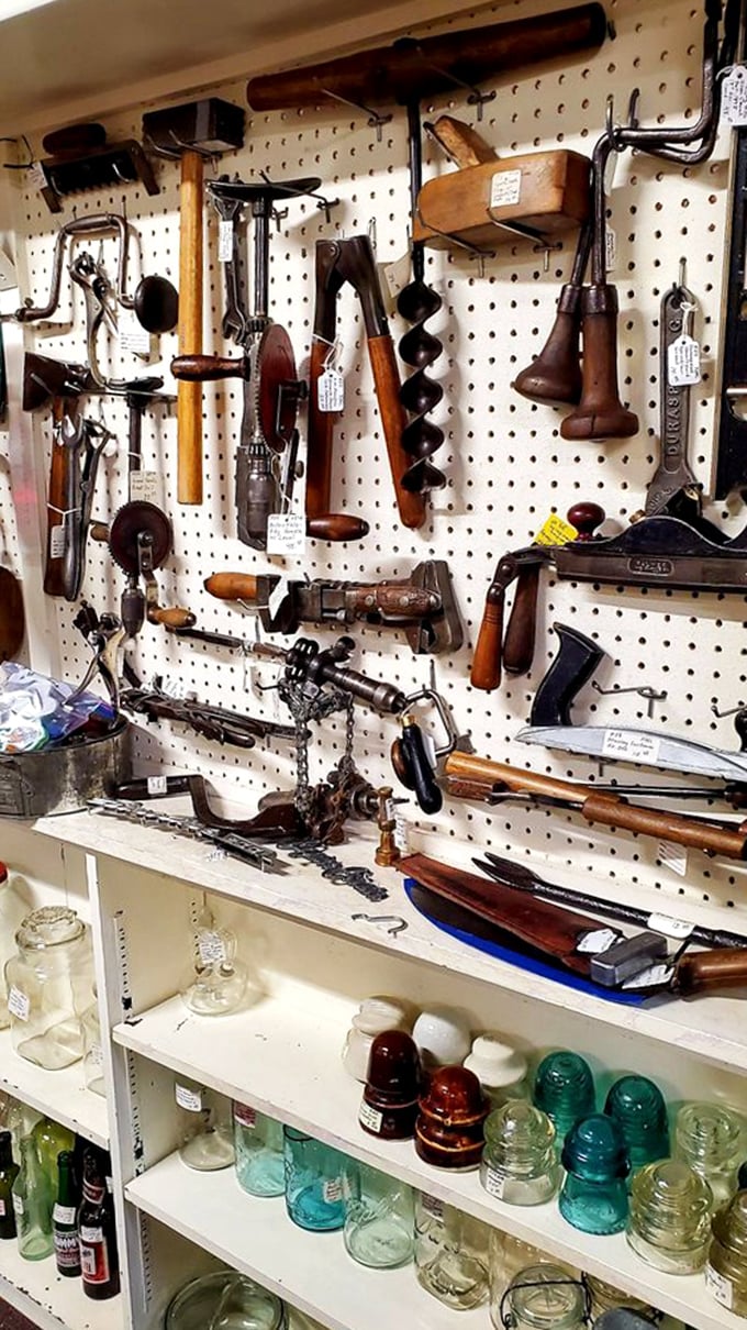 Tools that built Montana, hanging like industrial art—each wooden handle and metal implement telling stories of craftsmanship from when "built to last" wasn't just marketing.