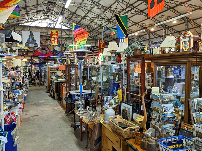Display cases filled with yesterday's treasures, today's finds, and tomorrow's conversation pieces. The ceiling flags add international flair to domestic clutter.