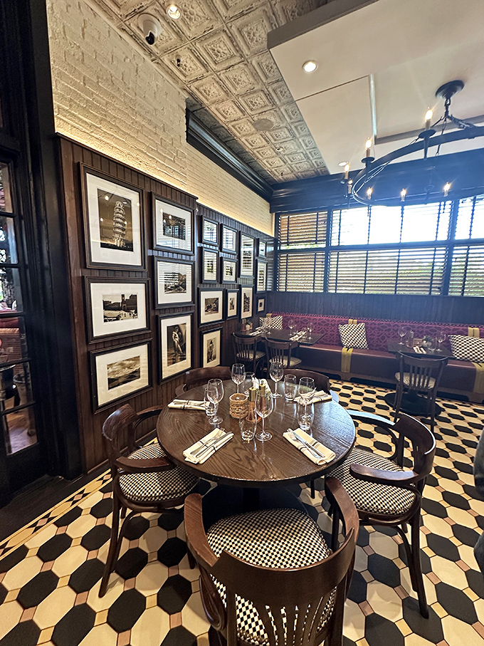 Black and white photos against wood paneling create a dining nook that feels like the coolest corner of Italy.