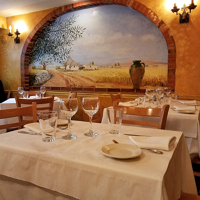 The Italian countryside mural isn't just decoration&mdash;it's foreshadowing the culinary journey your taste buds are about to embark on.