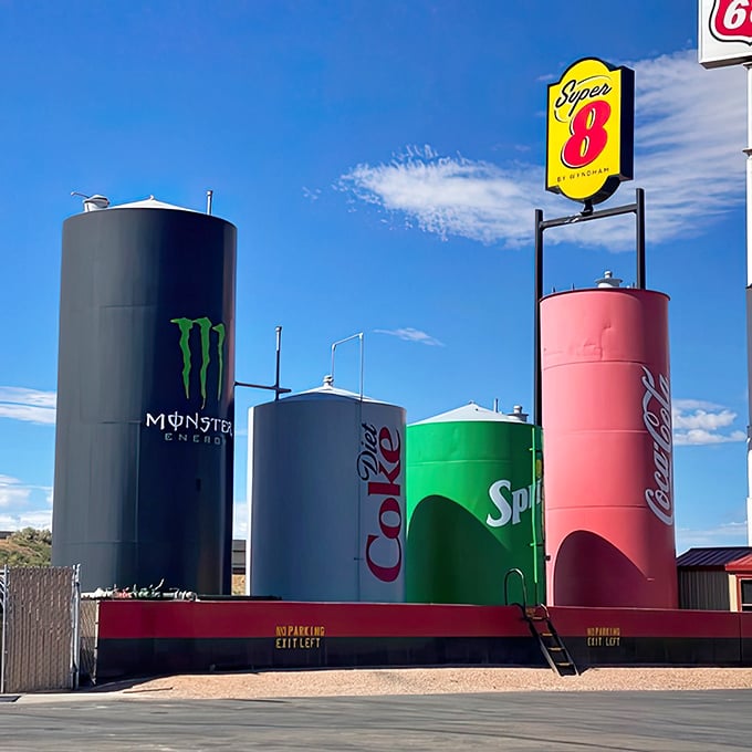 The quartet of cans stands proudly on their red platform, a roadside chorus line of carbonated celebrities.