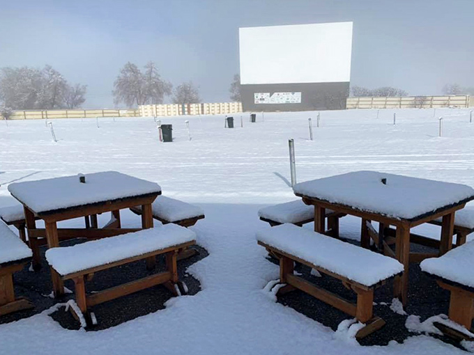 Even in winter's embrace, the silent screen waits patiently for summer nights and the return of movie magic.
