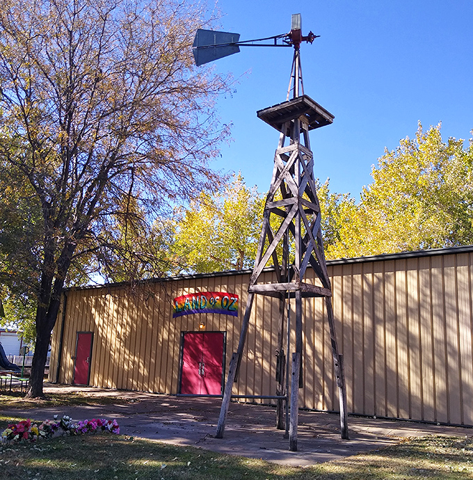 A Kansas windmill stands tall beside the Land of Oz building, a perfect nod to the tornado that started Dorothy's adventure.