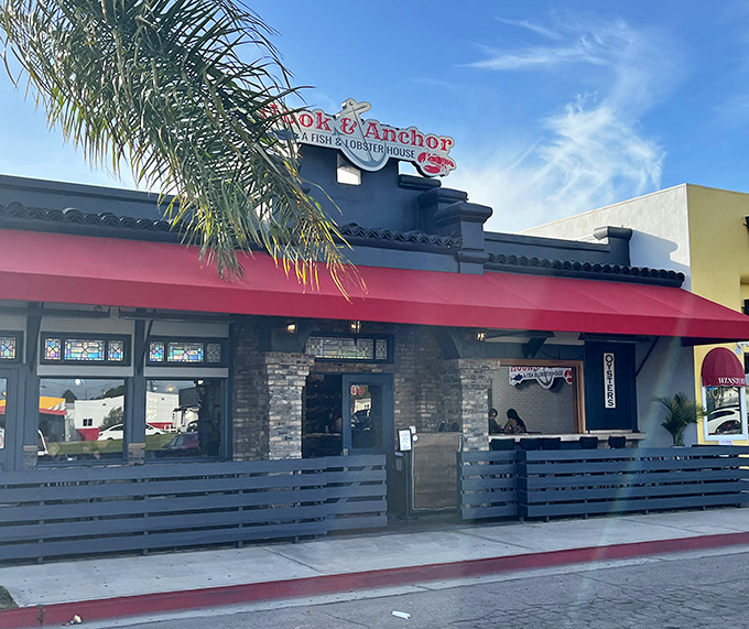Hook & Anchor's vibrant red awning signals seafood salvation ahead. This Costa Mesa gem promises fish and lobster worth anchoring down for!