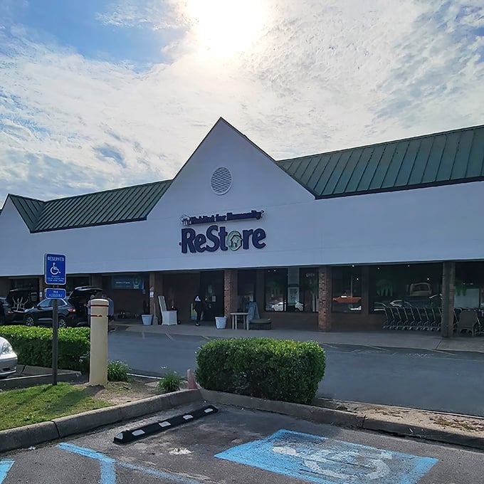 Accessible treasures await! Habitat ReStore's welcoming facade basks in heavenly sunbeams, practically guaranteeing divine deals inside.