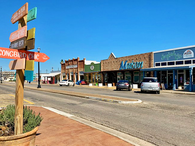 The quirky directional sign points to adventures while the historic buildings provide the perfect coastal town backdrop.