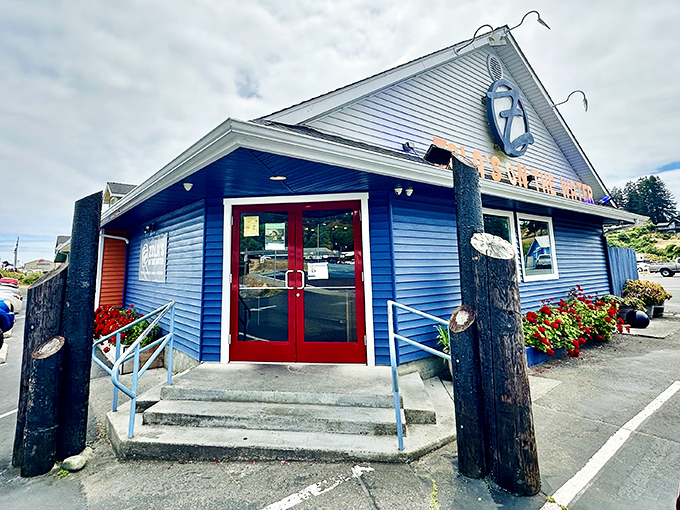 That pop of red door against Zola's blue building is your gateway to pizza paradise with a side of stunning coastal scenery.