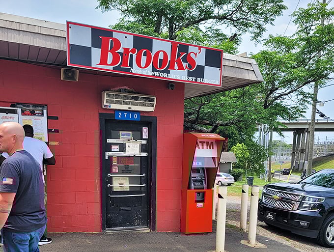 The humble entrance tells the whole story – no frills, just thrills. That ATM isn't decorative; it's your passport to burger paradise in this cash-only temple of taste.