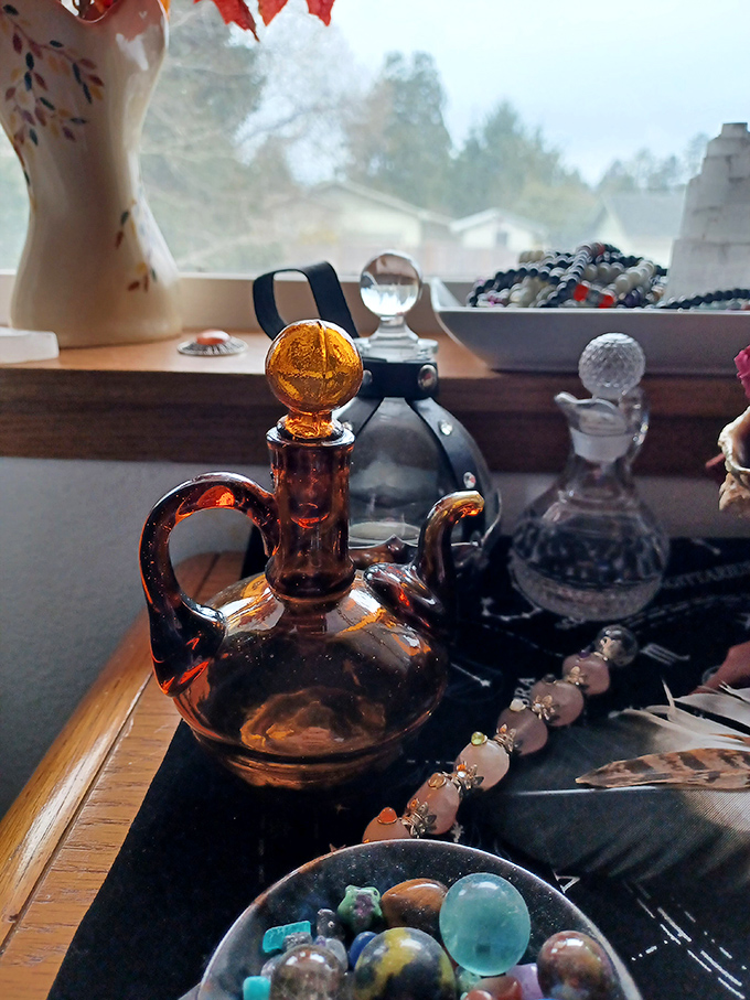 Amber glass catches the light like liquid honey, transforming ordinary windowsills into magical displays of color and history.