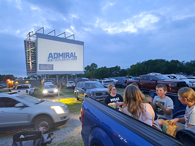 Pickup truck tailgates transform into premium seating as families create their own private screening rooms under Oklahoma skies.