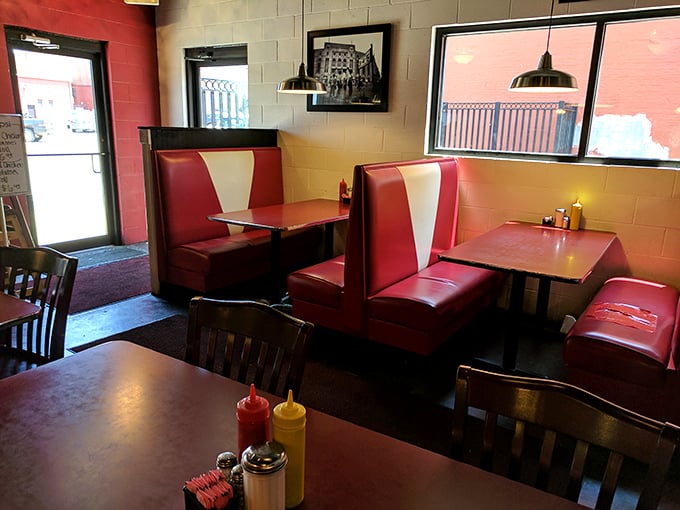Classic diner booths where memories are made between bites – these red vinyl seats have heard more stories than most therapists.