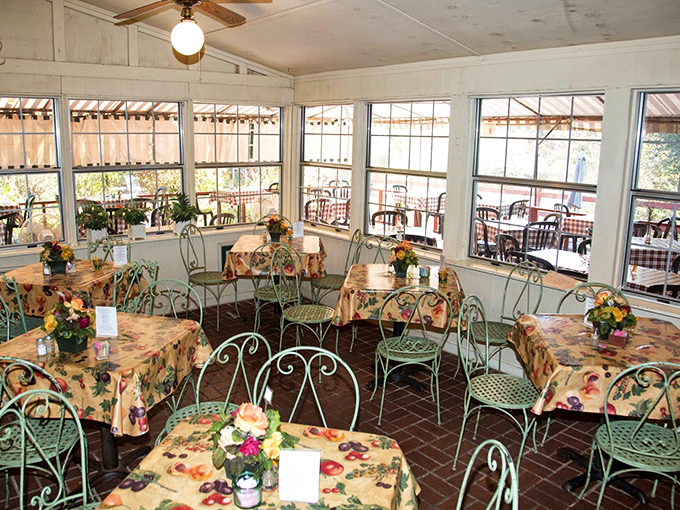 Sunlight streams through windows in this garden-inspired dining room, where mint green chairs and floral tablecloths create a grandmother's-garden vibe that soothes the soul.