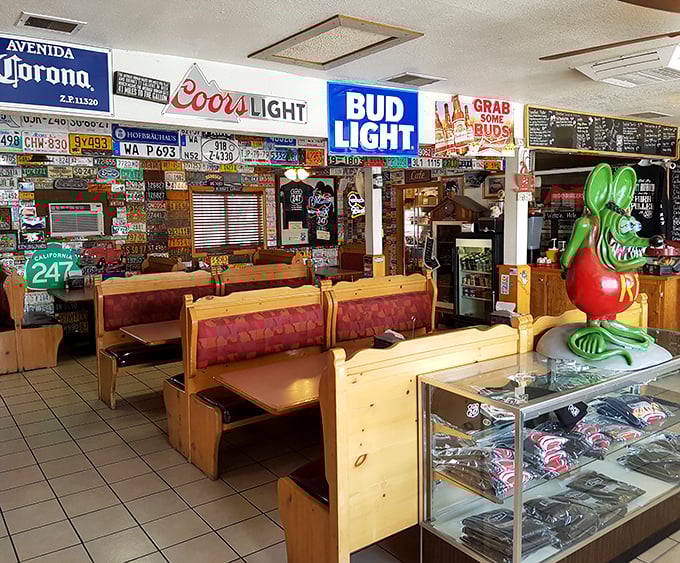 Beer signs illuminate wooden booths like roadside chapels. That green Rat Fink figure stands guard over memories made between bites of comfort food.