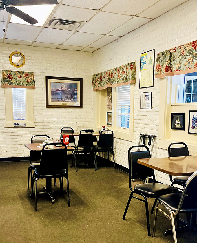 Cozy dining nooks with floral valances and framed pictures creating small-town charm.