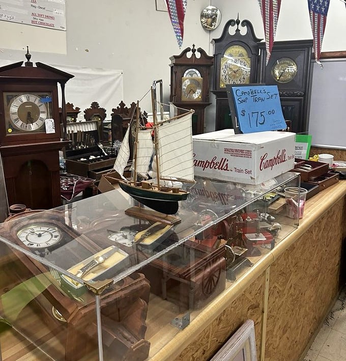 Antique grandfather clocks stand sentinel over treasures below, their mechanisms still ticking after decades of marking time's passage.