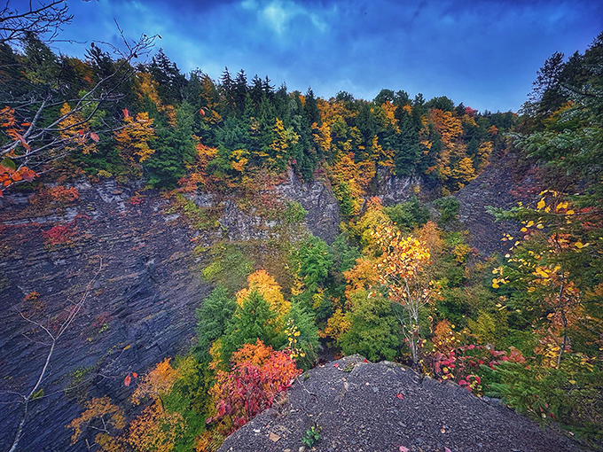 Fall foliage transforms the gorge into a painter's palette of reds and golds. Nature showing off its seasonal wardrobe change.