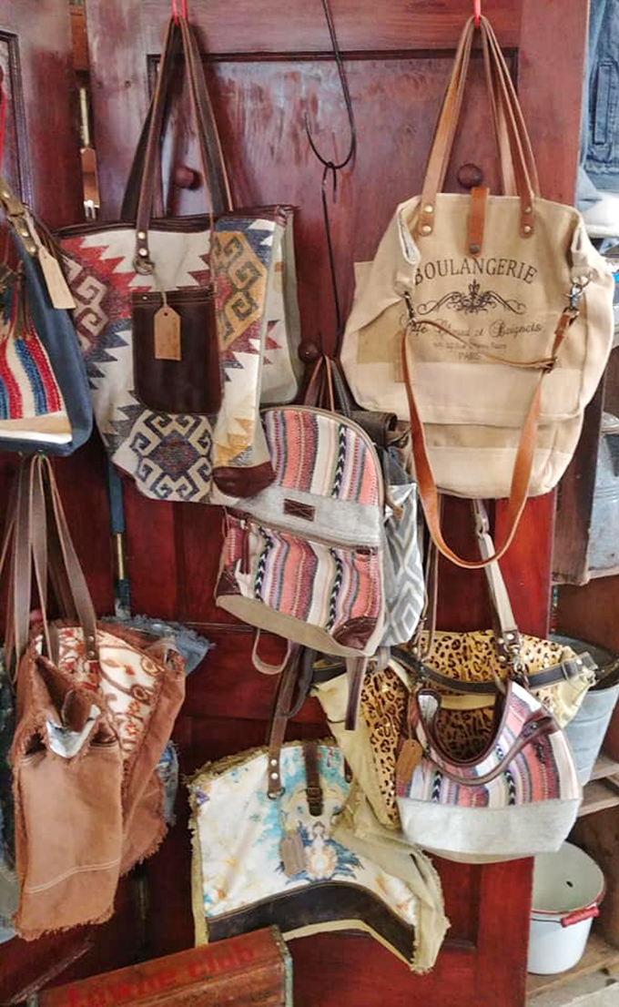Handbags hanging like exotic fruit, each one promising to be that perfect blend of fashion statement and portable storage solution.