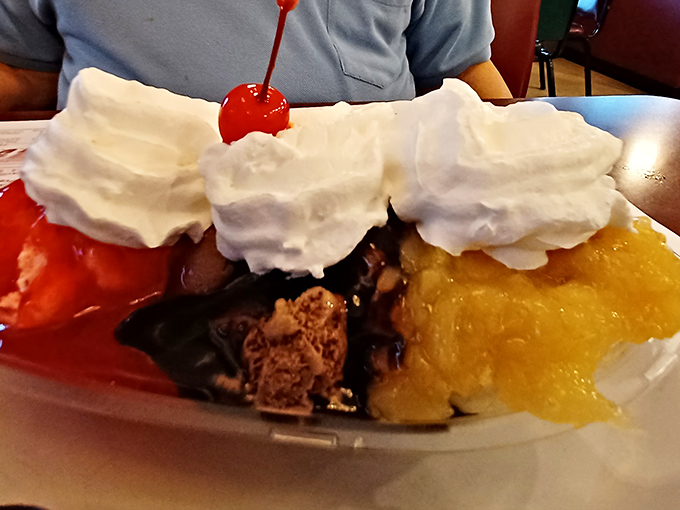 A dessert that demands attention! This banana split is a mountain of nostalgia topped with clouds of whipped cream and that essential cherry sentinel.