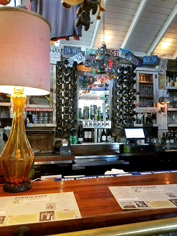 The bar, adorned with license plates and fishing memorabilia, serves as both beverage station and museum of coastal Americana that would make Hemingway feel right at home.