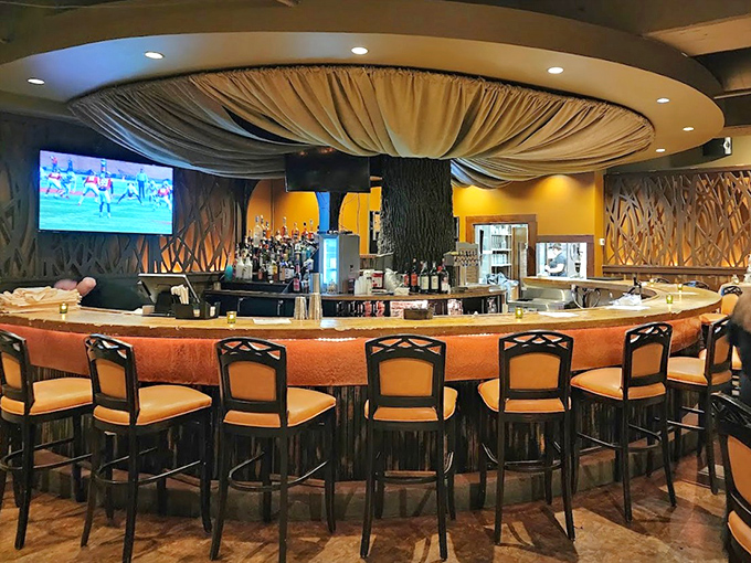 The circular bar invites camaraderie and conversation. With draped fabric overhead, it's part English pub, part royal banquet hall—all enjoyable.