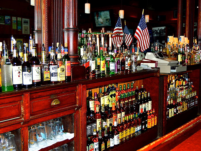 American flags stand proudly behind a bar stocked with every spirit imaginable&mdash;democracy in action is having this many choices for your next drink.