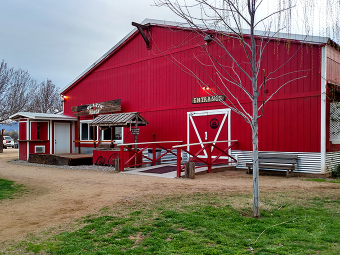 Blazin' M Ranch's red barn promises authentic Western experiences without the Hollywood tourist trap nonsense.