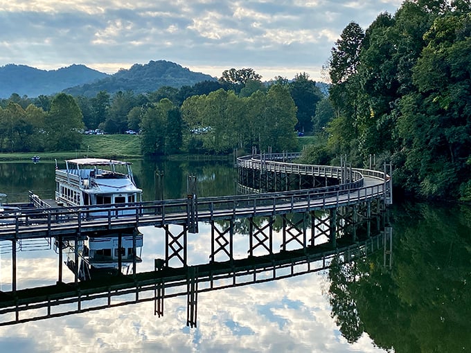 This serene boardwalk curves gracefully over still waters, reflecting both sky and surrounding hills. Nature's mirror offers twice the beauty for half the effort.