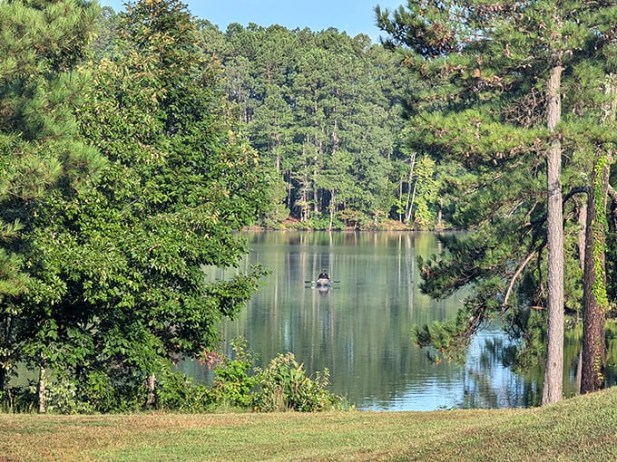 A lone boater finds solitude in the middle distance&mdash;proof that sometimes the best social networking happens without Wi-Fi.