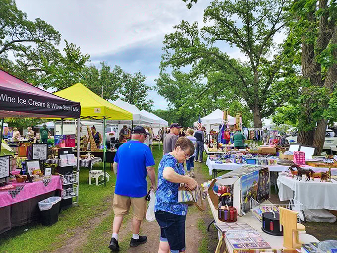 Colorful tents create a patchwork village where vendors display their wares like proud parents showing off family photos&mdash;each item has a story.