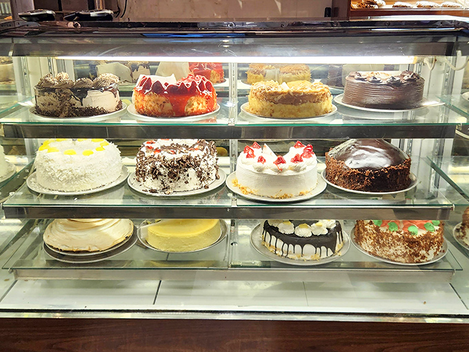 The cake display case – or as I call it, "The Museum of Delicious Decisions." Each shelf offers a different path to dessert nirvana.
