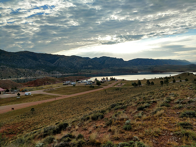 Civilization meets wilderness at Seminoe's edge, where campsites nestle against mountains like nature's own five-star accommodations with unbeatable views.