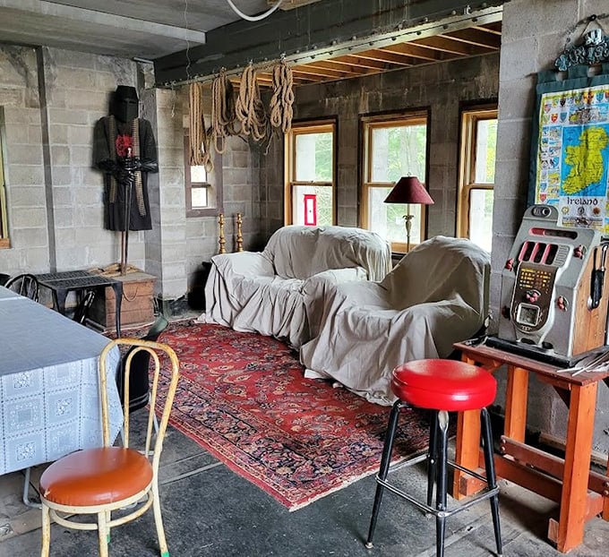 The castle lounge blends medieval stone with modern comforts, including what appears to be a vintage slot machine. Knights of the Round Table, meet Vegas. 