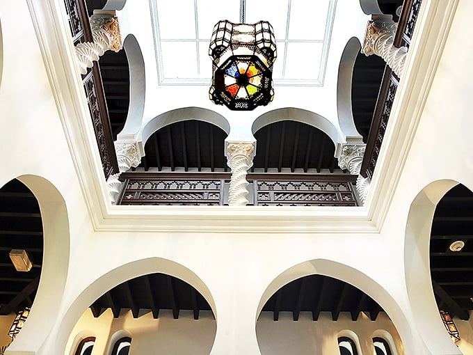 Looking up reveals horseshoe arches and a stained-glass skylight that proves someone really committed to this vision.