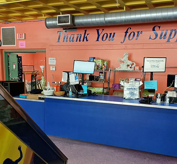 The checkout counter's "Thank You for Supporting" sign reminds shoppers their bargain hunting powers community programs too.