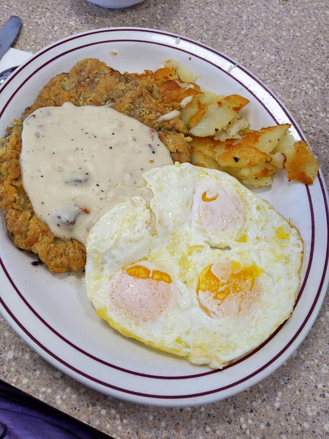 Chicken fried steak smothered in gravy with eggs sunny-side up&mdash;because sometimes breakfast should be an event, not just a meal.