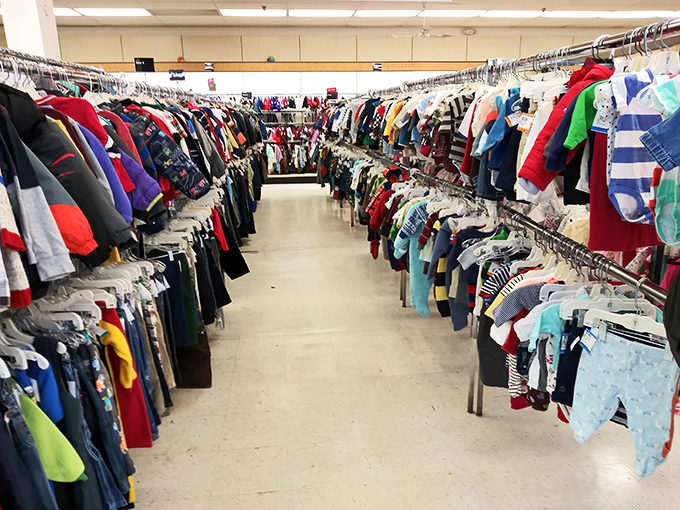 Children's clothing arranged by size, not season &ndash; a rainbow river of tiny garments that kids will outgrow before they outwear.