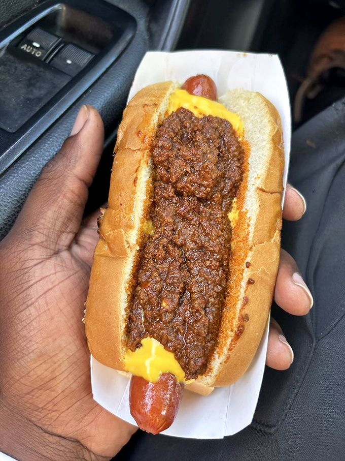 The chili cheese dog in its natural habitat—being devoured in a car. Some pleasures are too urgent to wait for a table.