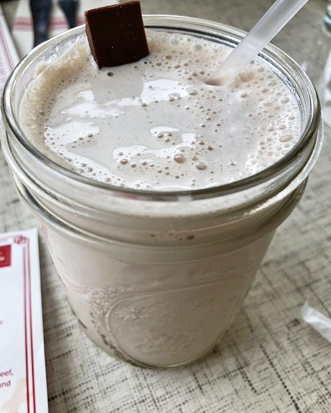A milkshake so thick it's practically a stand-up comedian with a sweet punchline. That chocolate square garnish isn't just decoration&mdash;it's a preview of coming attractions.