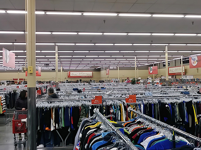 The thrill of the hunt in action. Shoppers navigate the carefully organized clothing sections, where yesterday's fashion becomes tomorrow's vintage find.